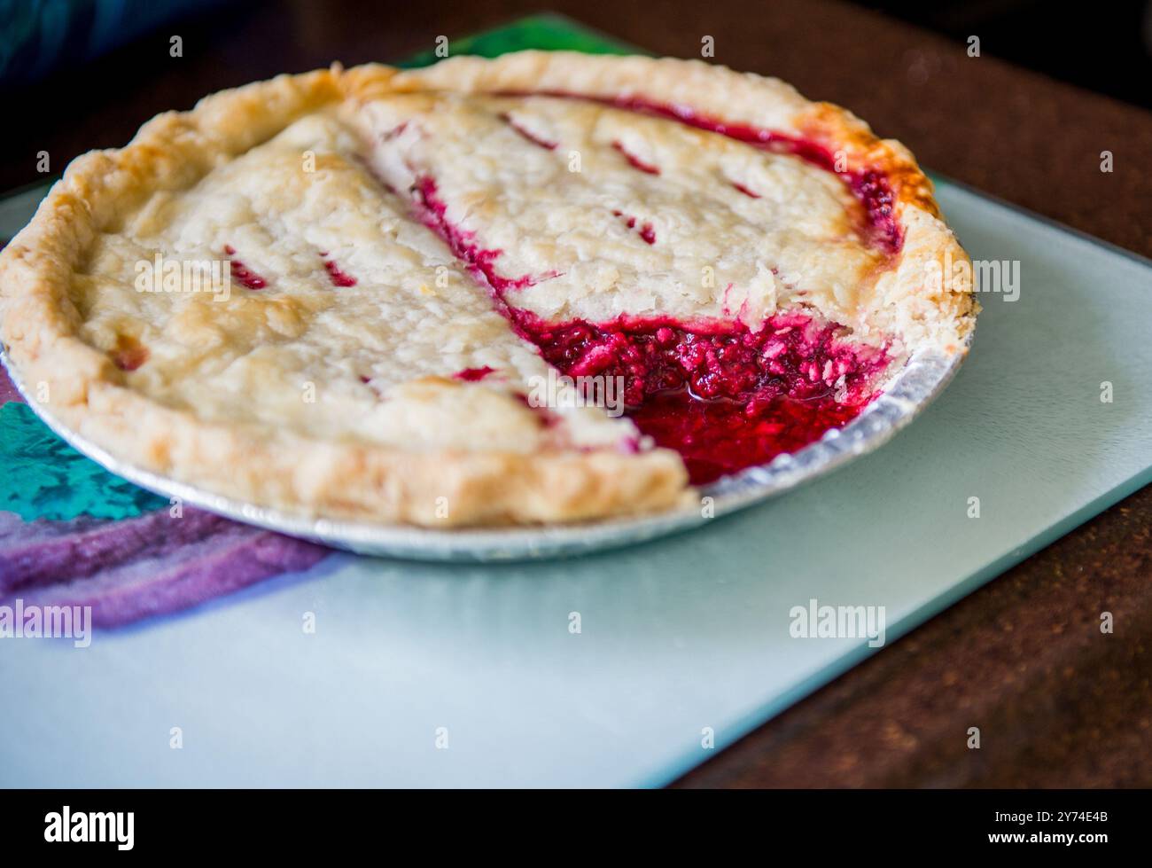 Photography of a homemade raspberry pie with one slice missing Stock ...
