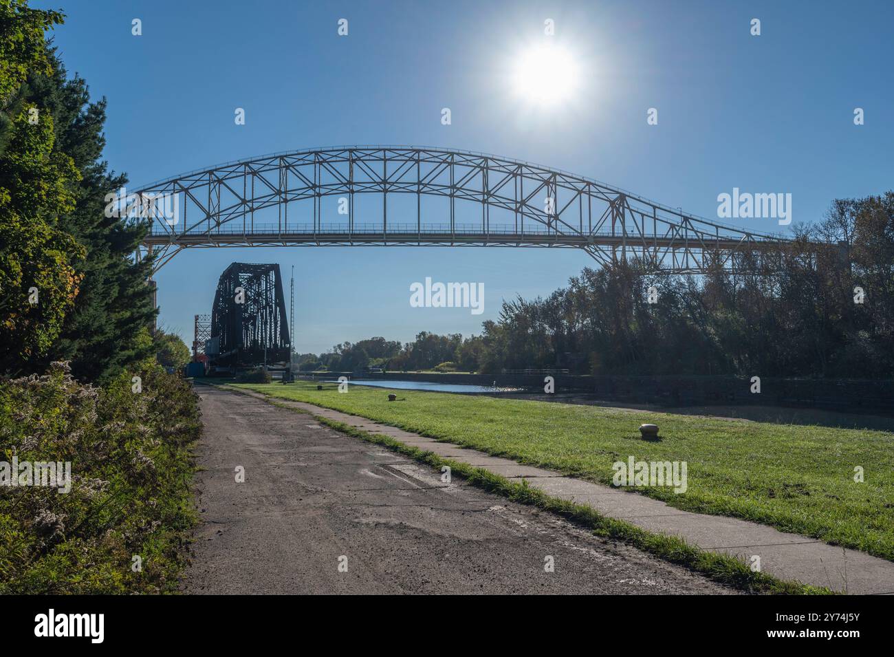 International Bridge Spans Across the Canal. Bright rising sun above ...