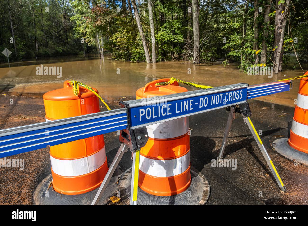 Police barricade across a flooded street near the Yellow River in Metro ...