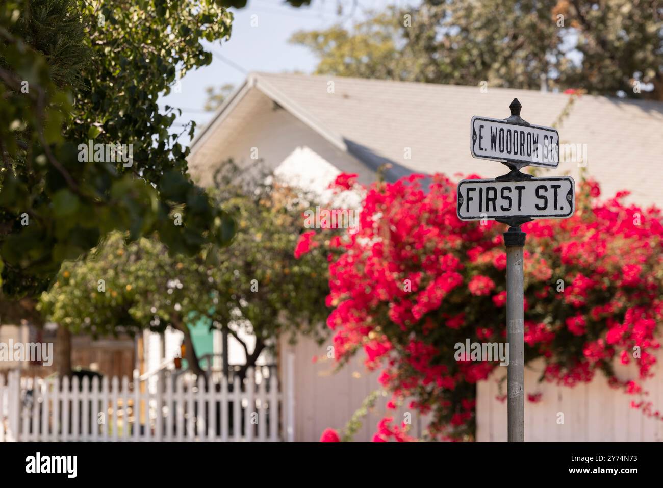 Historic street signs and neighborhood background of housing near ...