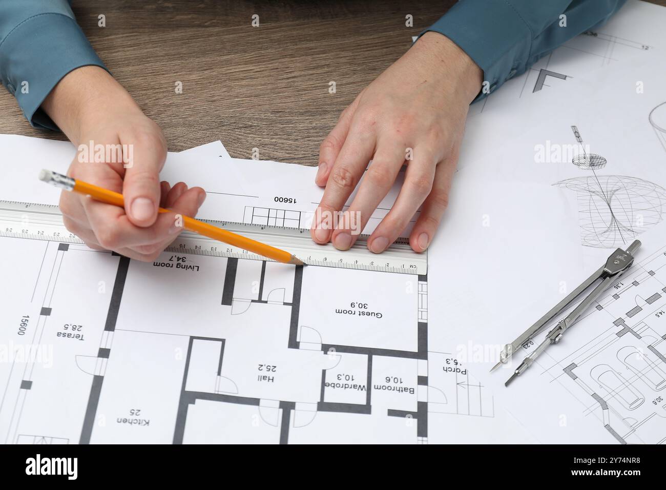 Architect working with project, closeup. Different technical drawings on wooden table Stock ...