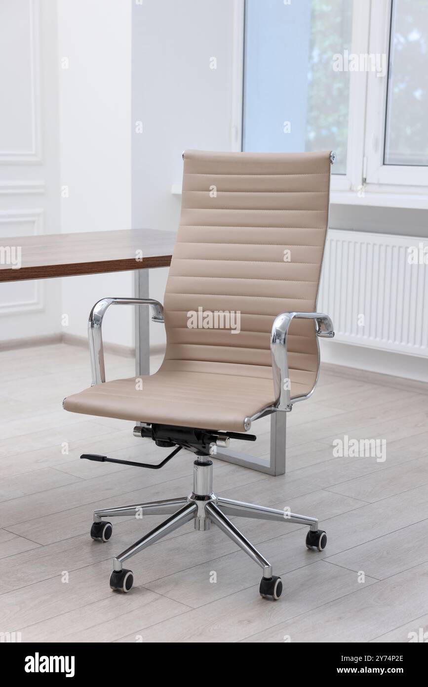 Beige leather chair and desk in office Stock Photo - Alamy