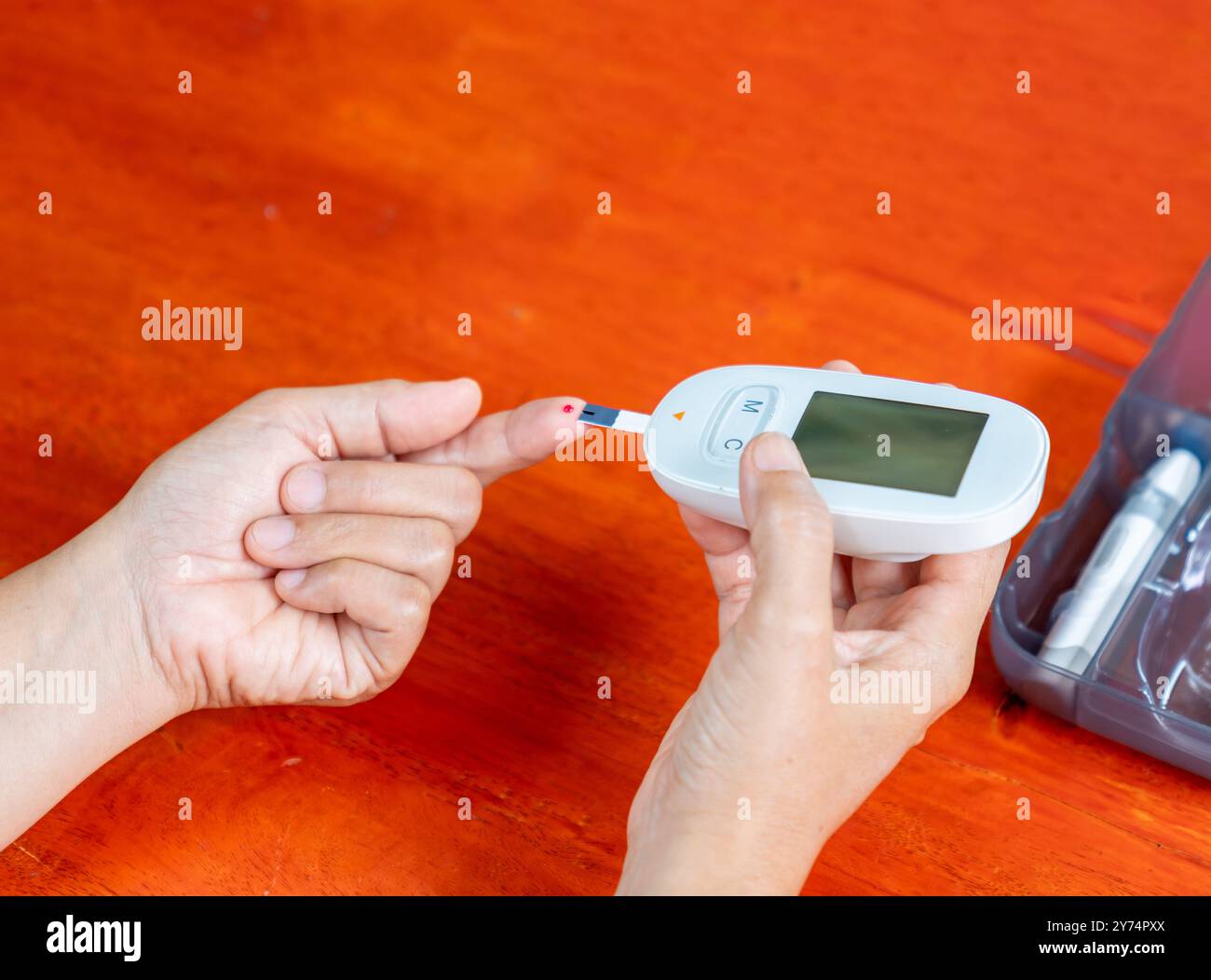 Closeup test Blood Glucose with glucose meter for Diabetes at home ...