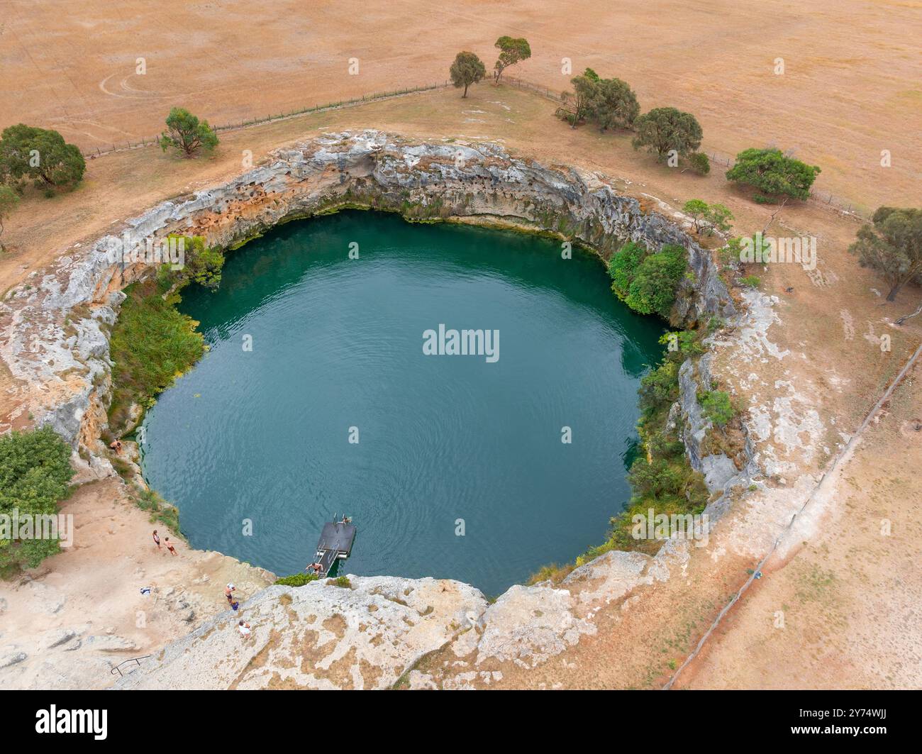 Aerial view of a small blue lake in a limestone sinkhole at Mout Schank ...