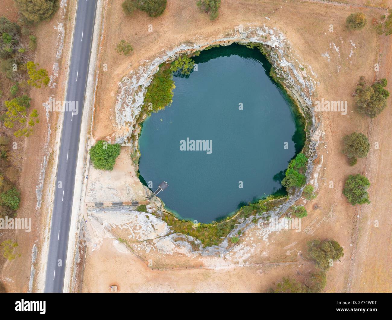 Aerial view of a small blue lake in a limestone sinkhole at Mout Schank ...