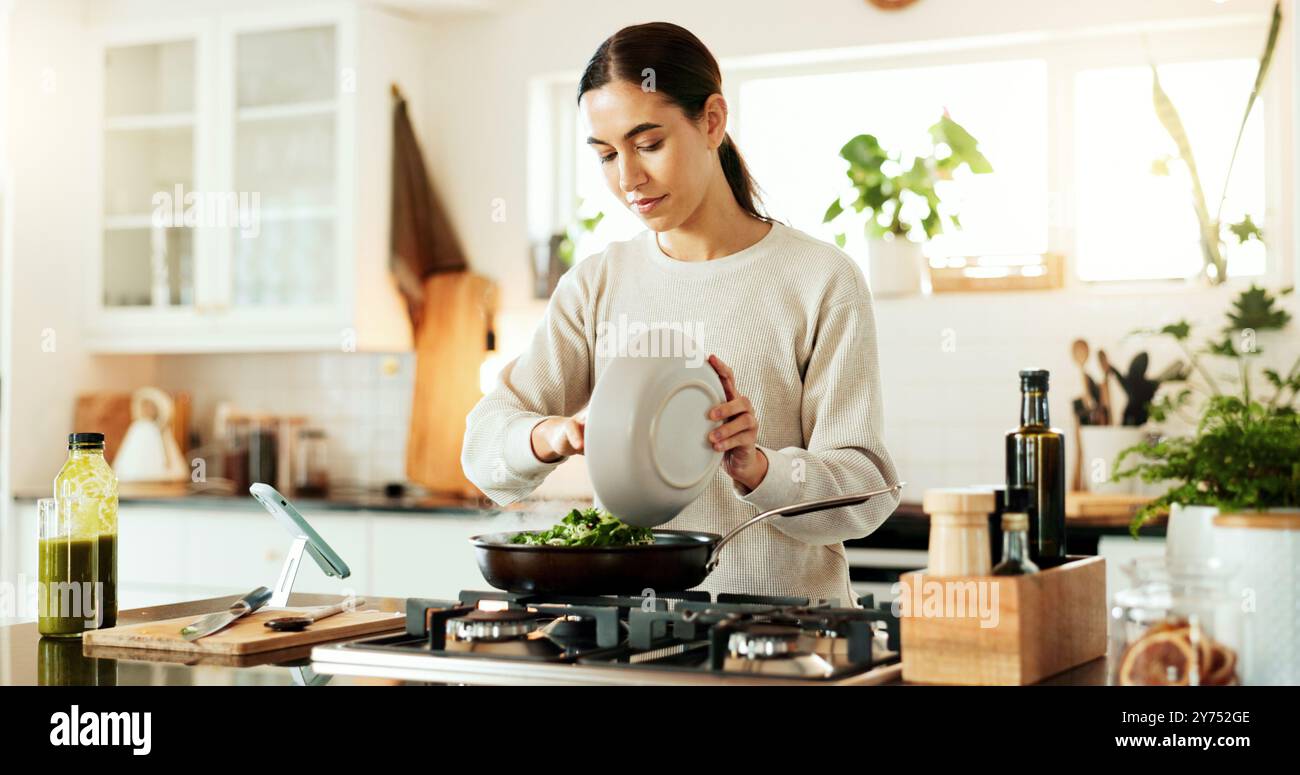 Woman, cooking and green salad in kitchen with phone for live streaming ...