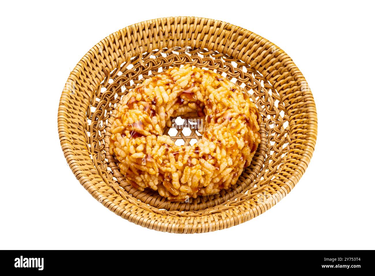 High angle view of single homemade crispy rice cracker in bamboo basket ...