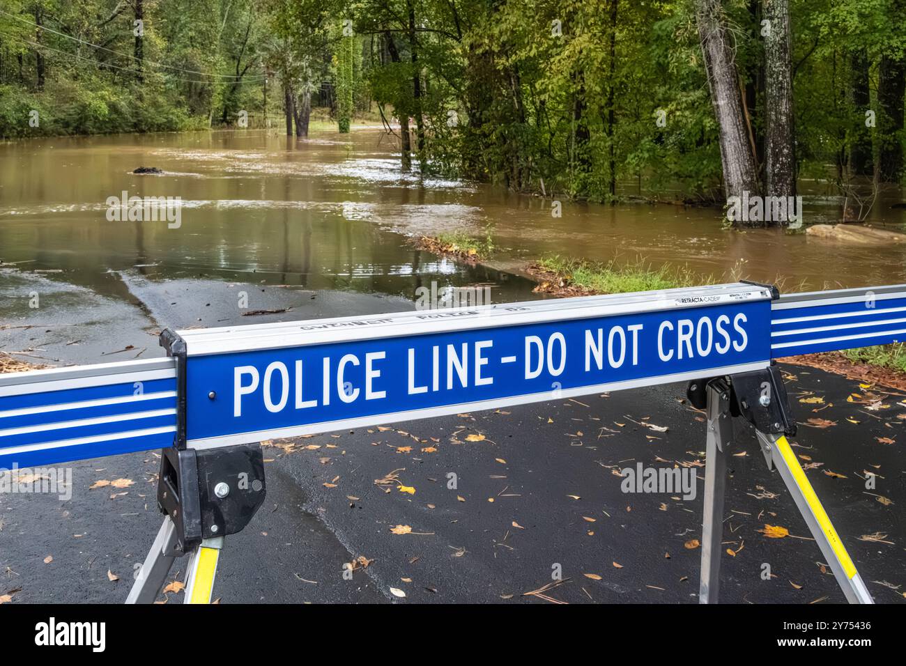 Police barricade across a flooded street near the Yellow River in Metro ...