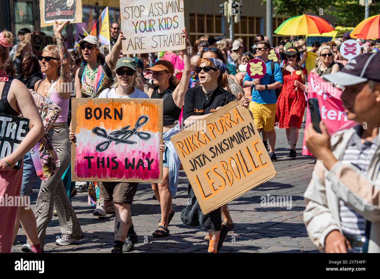 Women with cardboard signs at Helsinki Pride 2024 Parade on ...