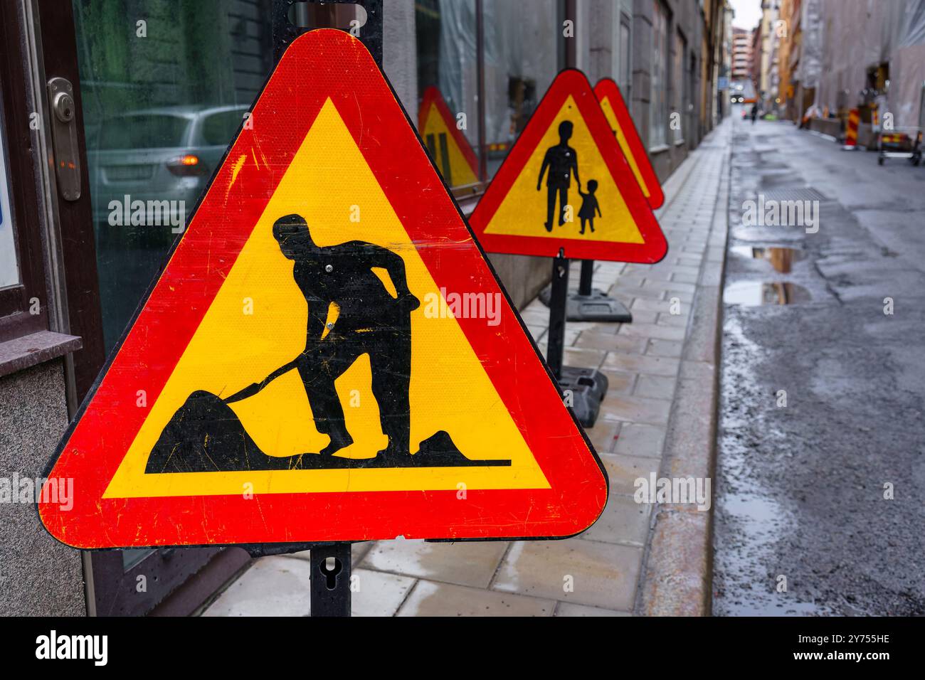 Road construction warning sign on a city street, close up Stock Photo ...