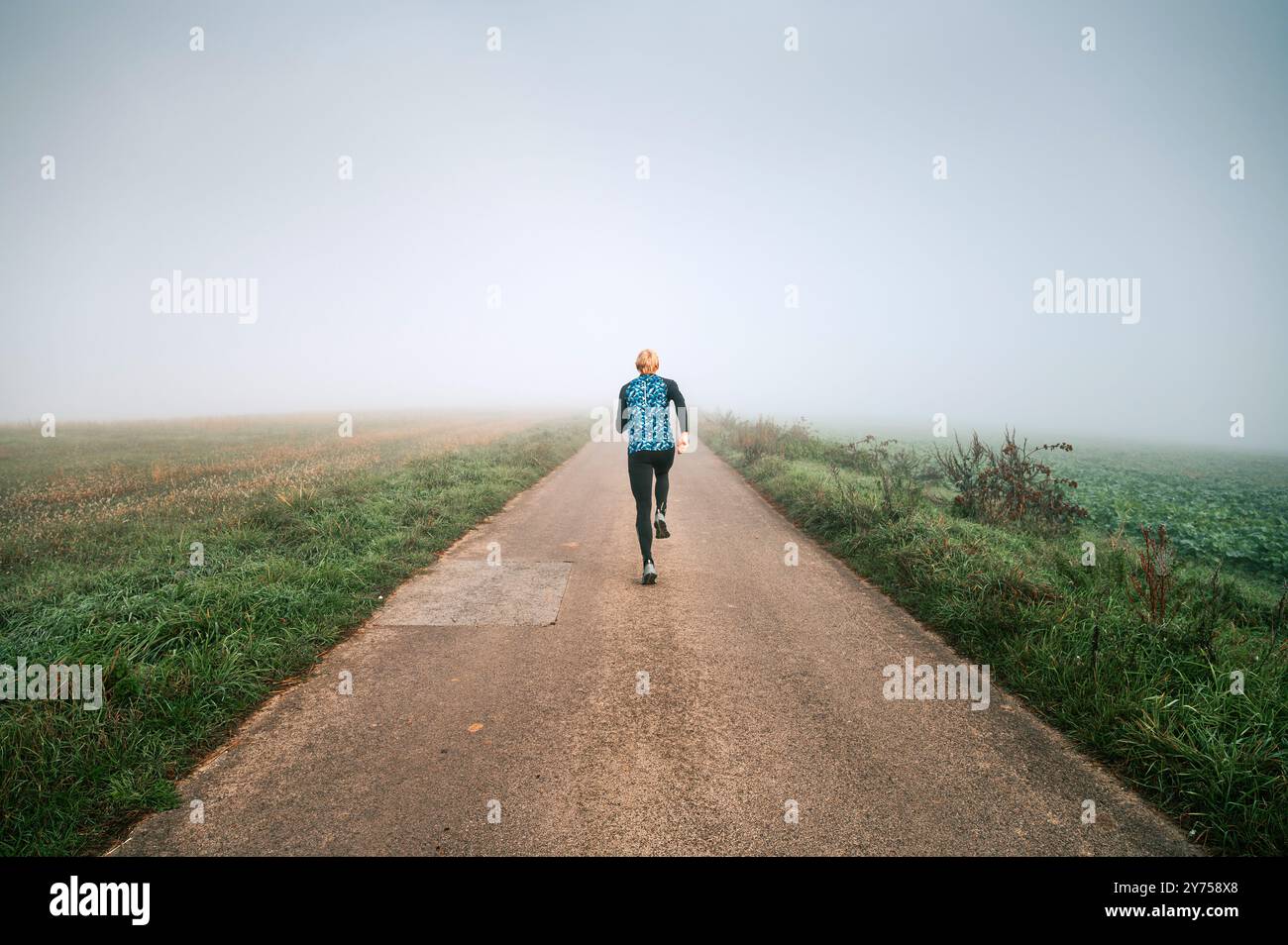 Runner in orange mist creates a serene moment in nature Stock Photo - Alamy