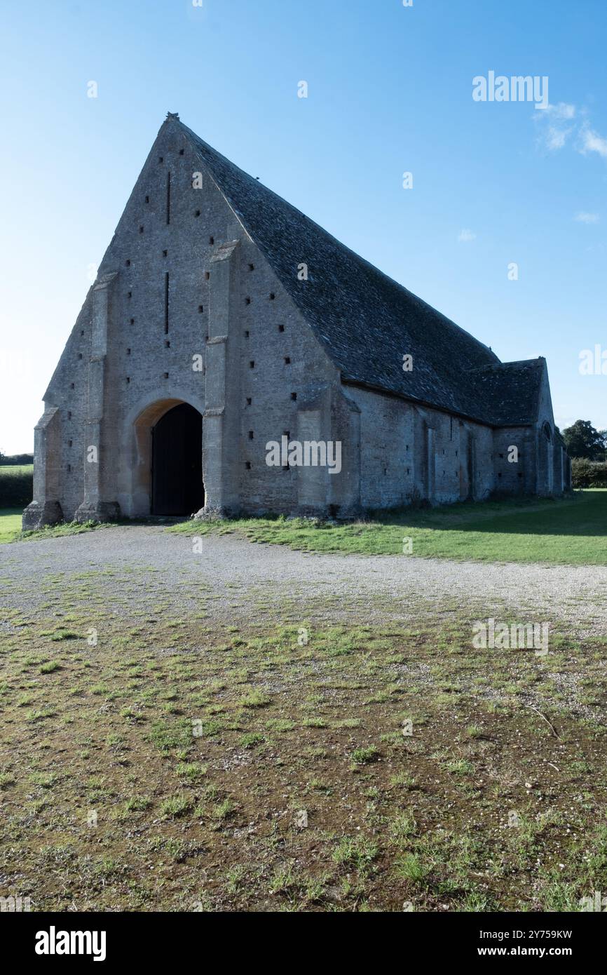 A historic stone barn under a clear blue sky, showcasing medieval ...