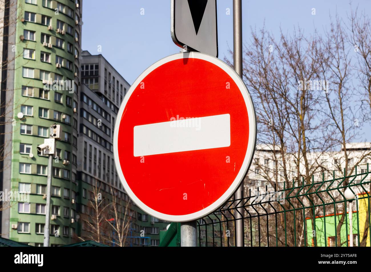 A bright red no entry sign, prominently featuring a white horizontal ...