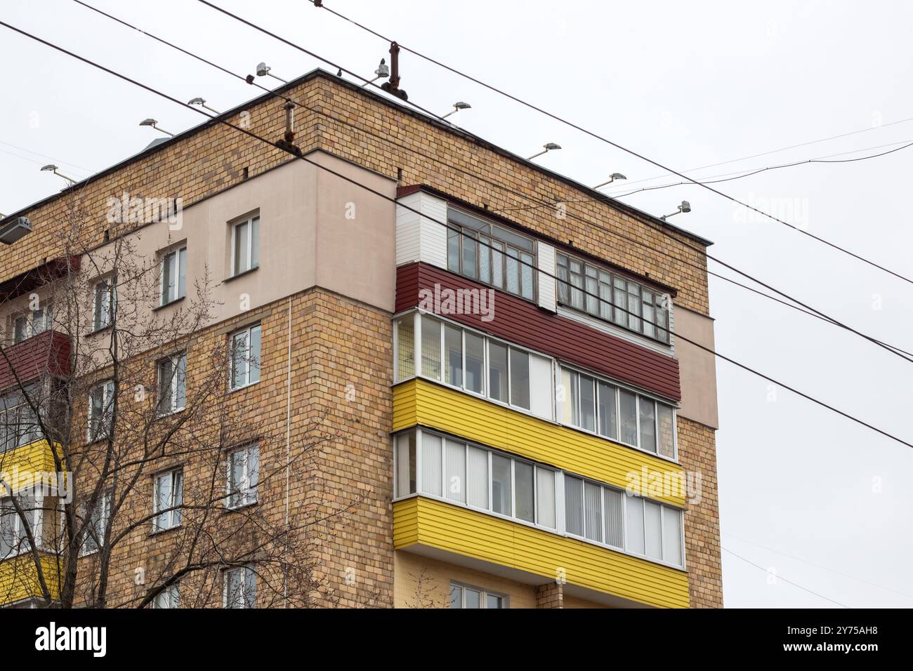 A solid brick building featuring a balcony located at the top of the ...