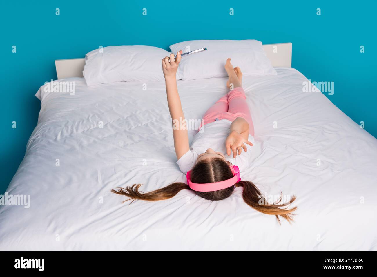 Photo of pretty lovely cute girl lying comfortable bed relax rest hold ...