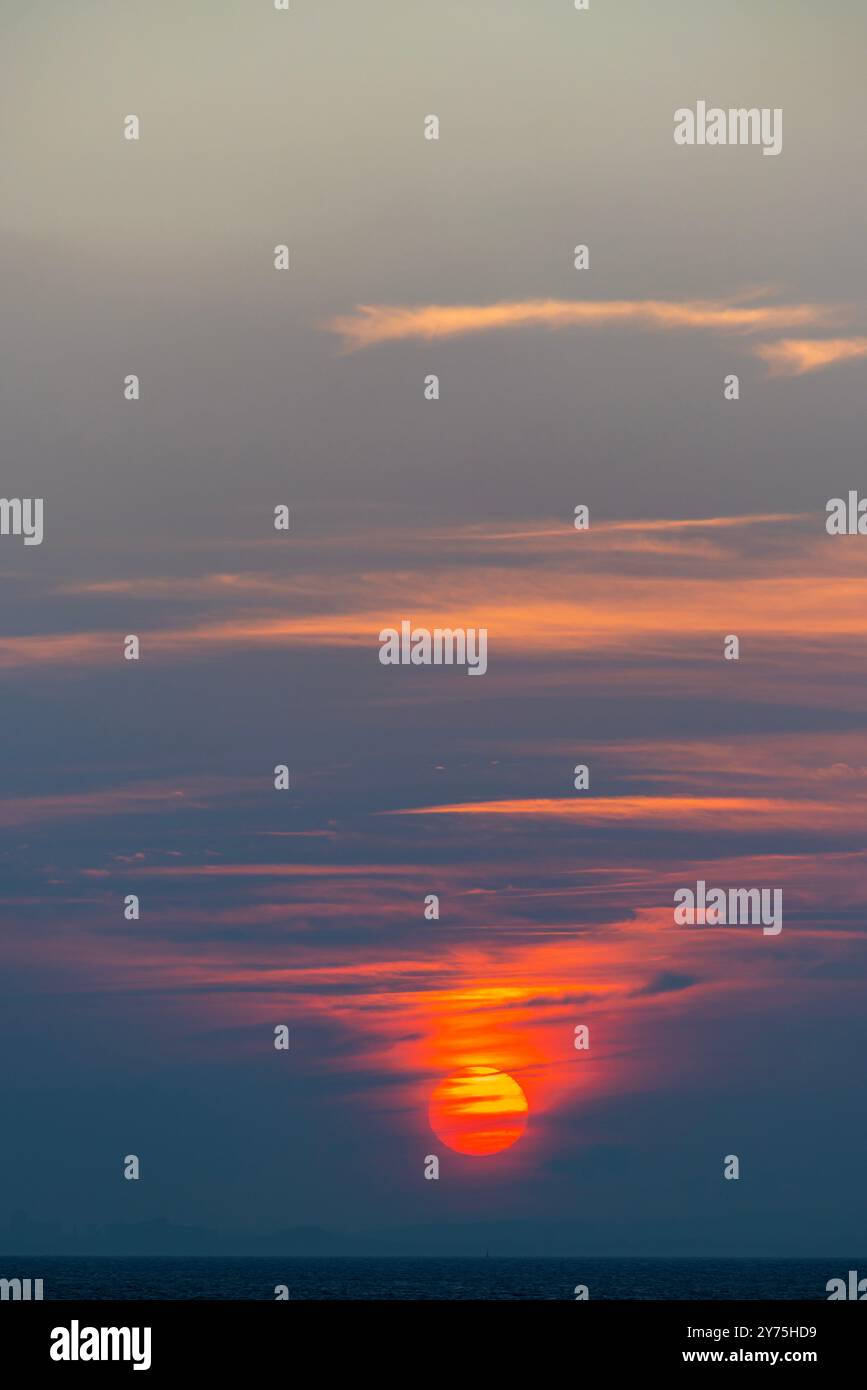 The slowly disappearing into cloud over the Welsh coast at sunset Stock ...