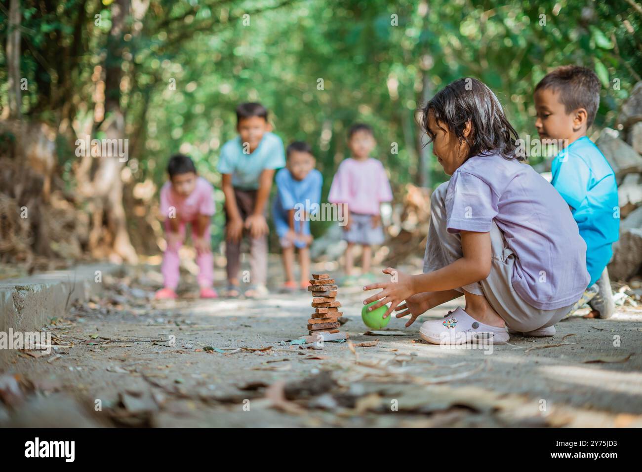 asian kids catching ball hitting stacked rooftile Stock Photo - Alamy