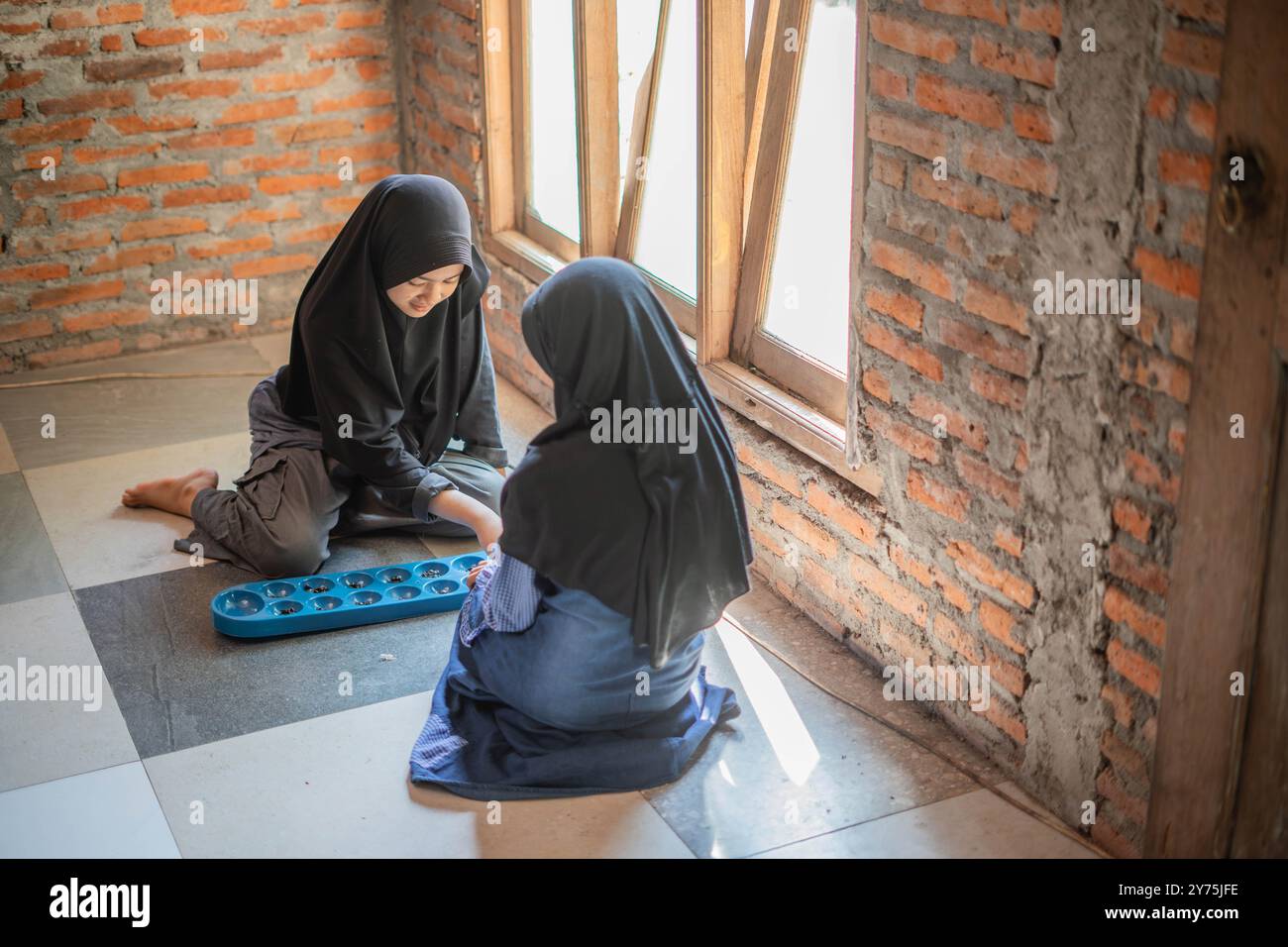 young hijab girls playing congklak indonesian traditional games Stock ...