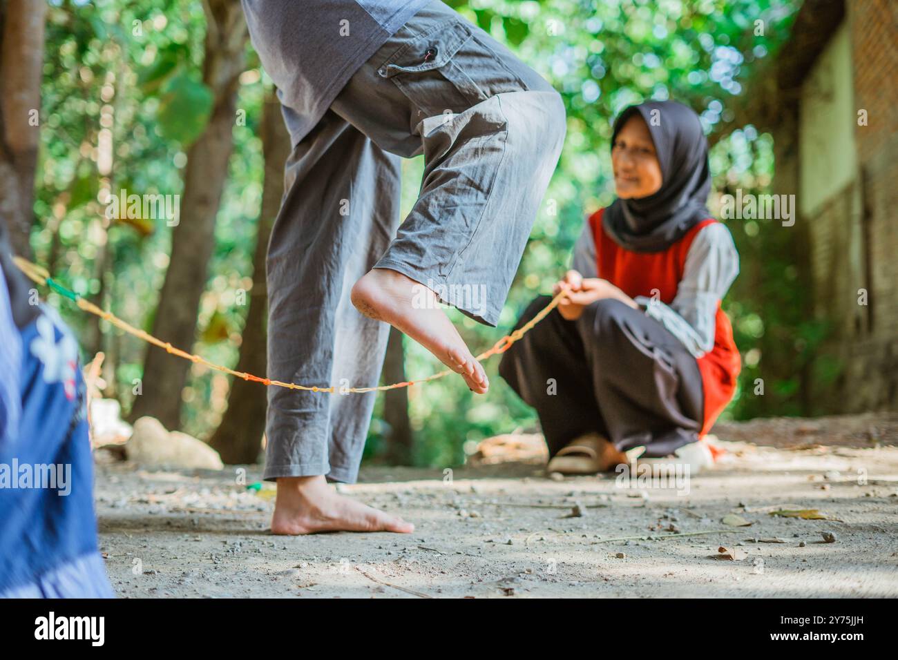 barefoot feet girl playing rope skipping Stock Photo - Alamy