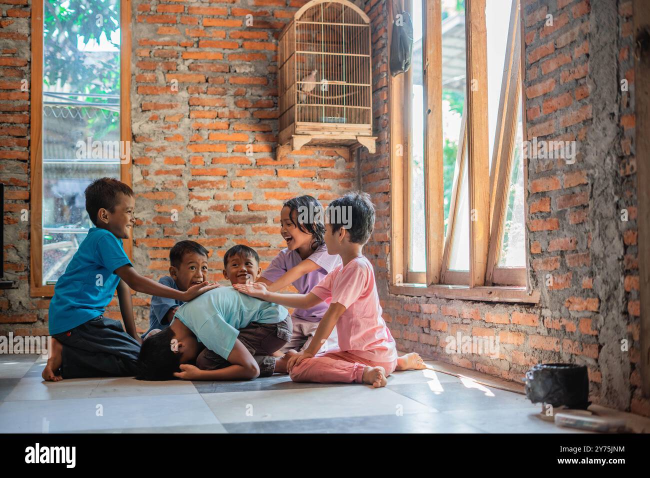 indonesian children playing traditional game indoors Stock Photo - Alamy