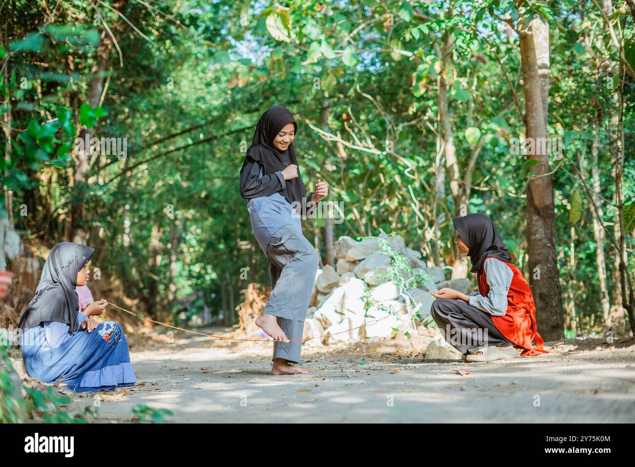 barefoot hijab girl jumping on rope Stock Photo - Alamy