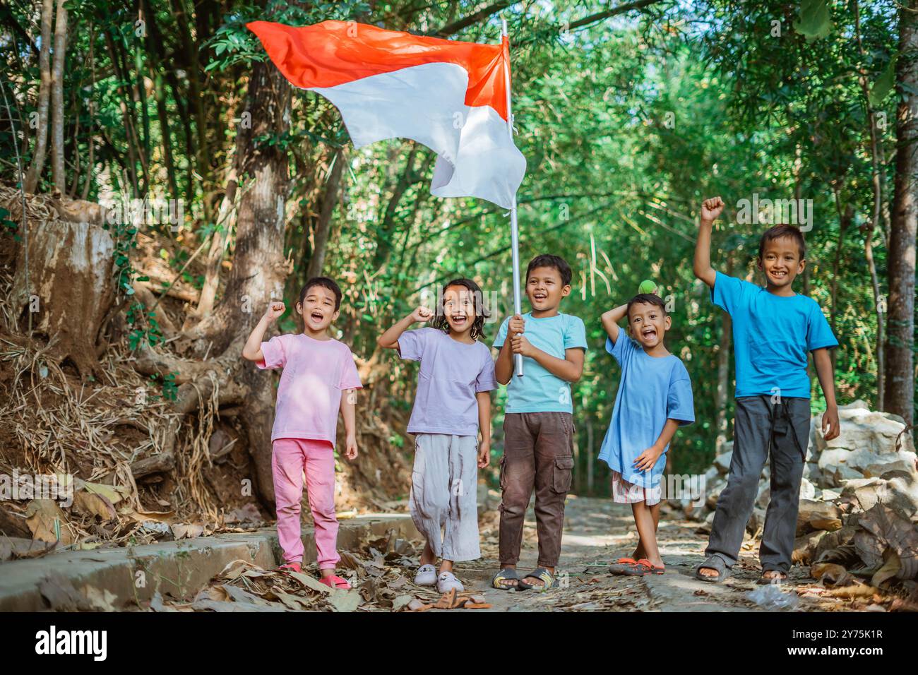 indonesian kids waving national flag and raising hand Stock Photo - Alamy