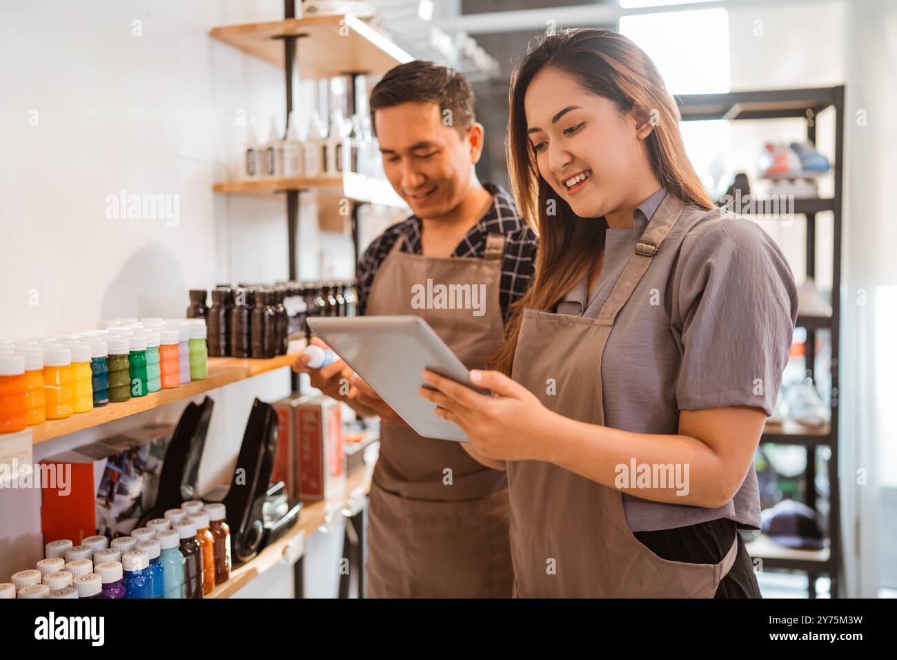 asian female worker checking supplies at paint store Stock Photo - Alamy