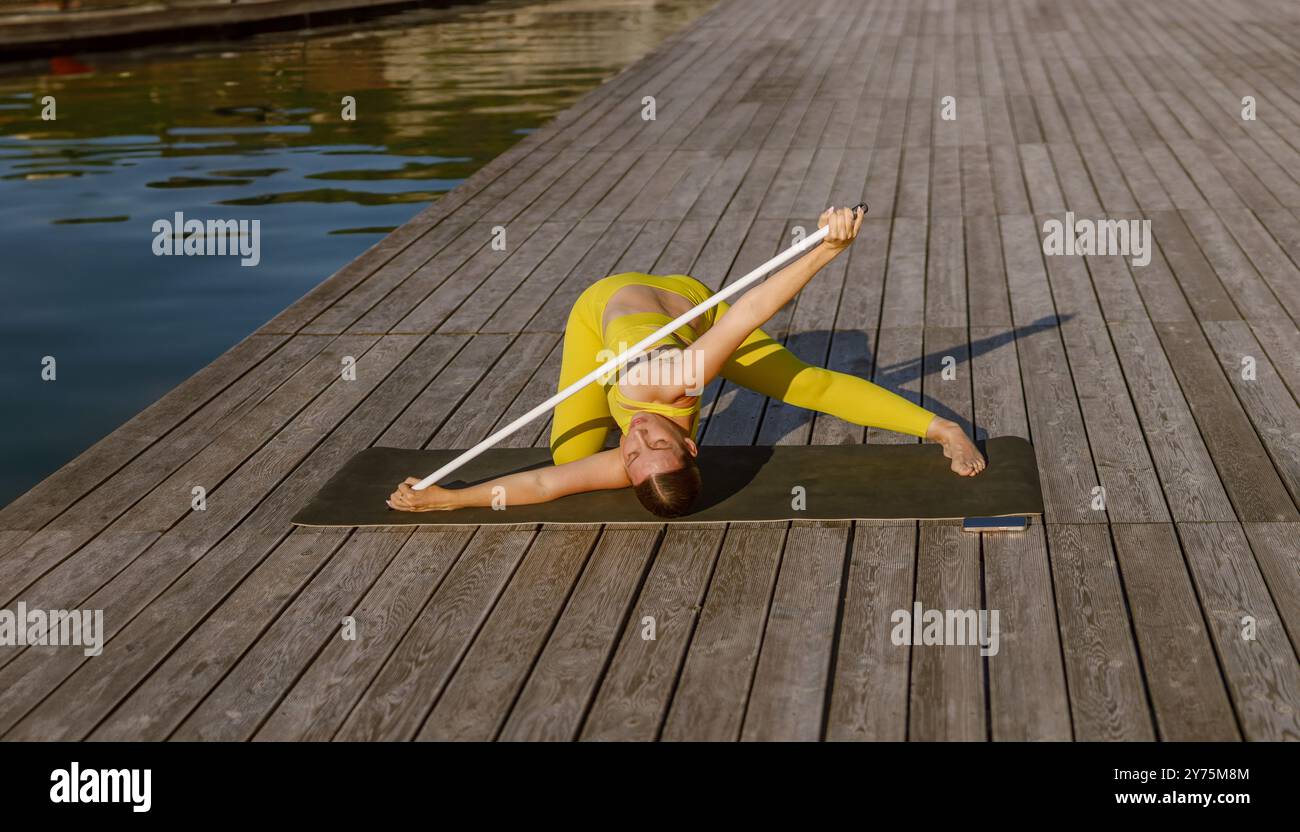 Participating in a Dynamic Yoga Pose on a Beautiful Scenic Dock ...