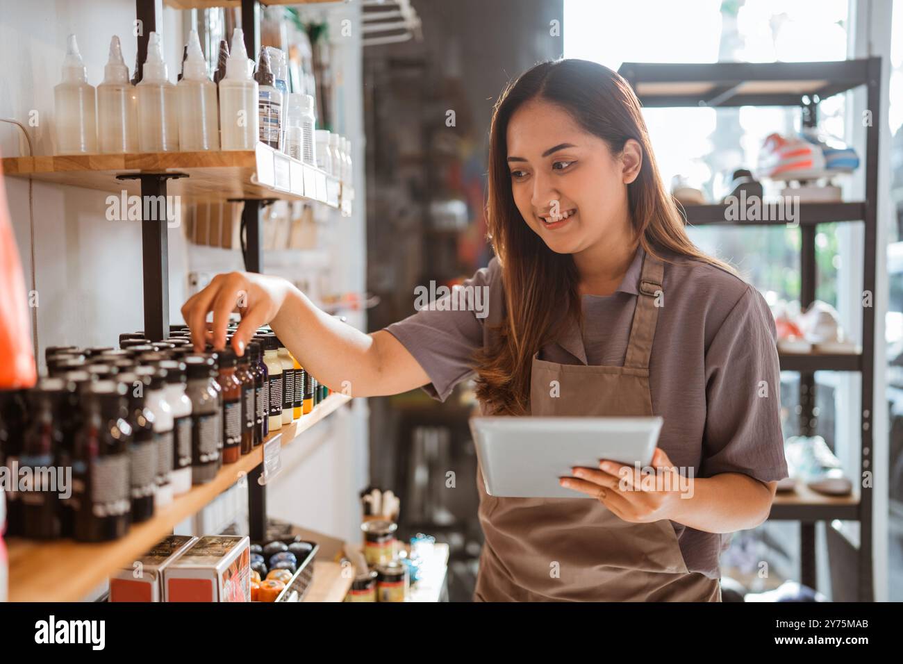 female worker checking paint products using tablet Stock Photo - Alamy