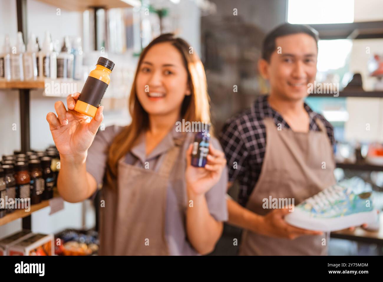 staff holding paint product for shoes Stock Photo - Alamy