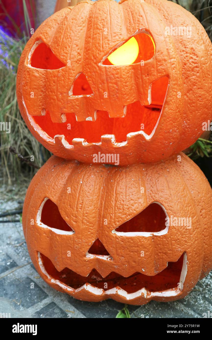 Stack of Lit Halloween Jack O Lantern Pumpkins in the Yard Stock Photo ...