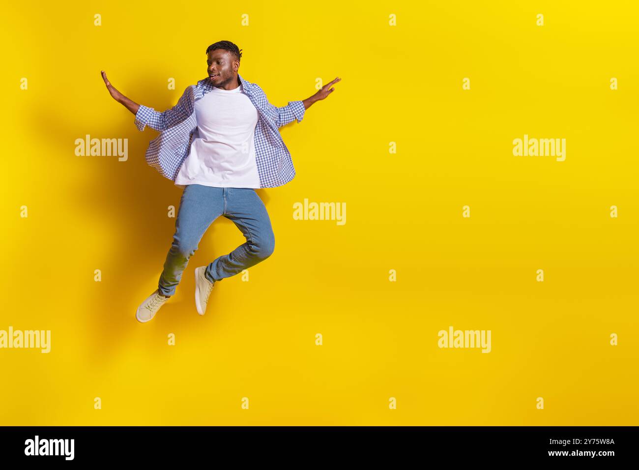 Full length photo of attractive funny guy wear plaid shirt jumping high ...