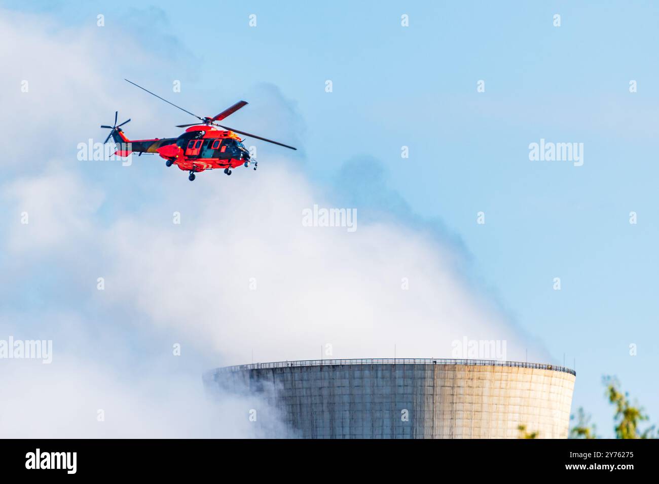 UME helicopter flying over a cooling tower at a nuclear power plant ...