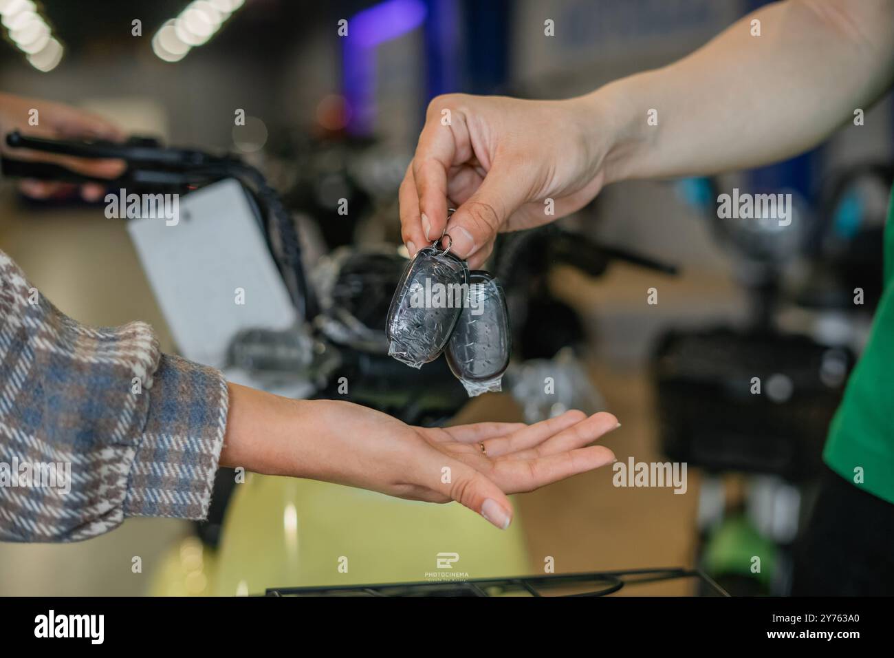 salesman hand over new key female customer Stock Photo - Alamy