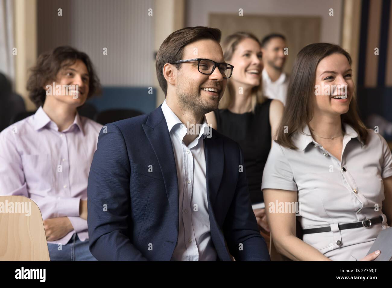 Happy cheerful audience of managers attending conference, meeting ...