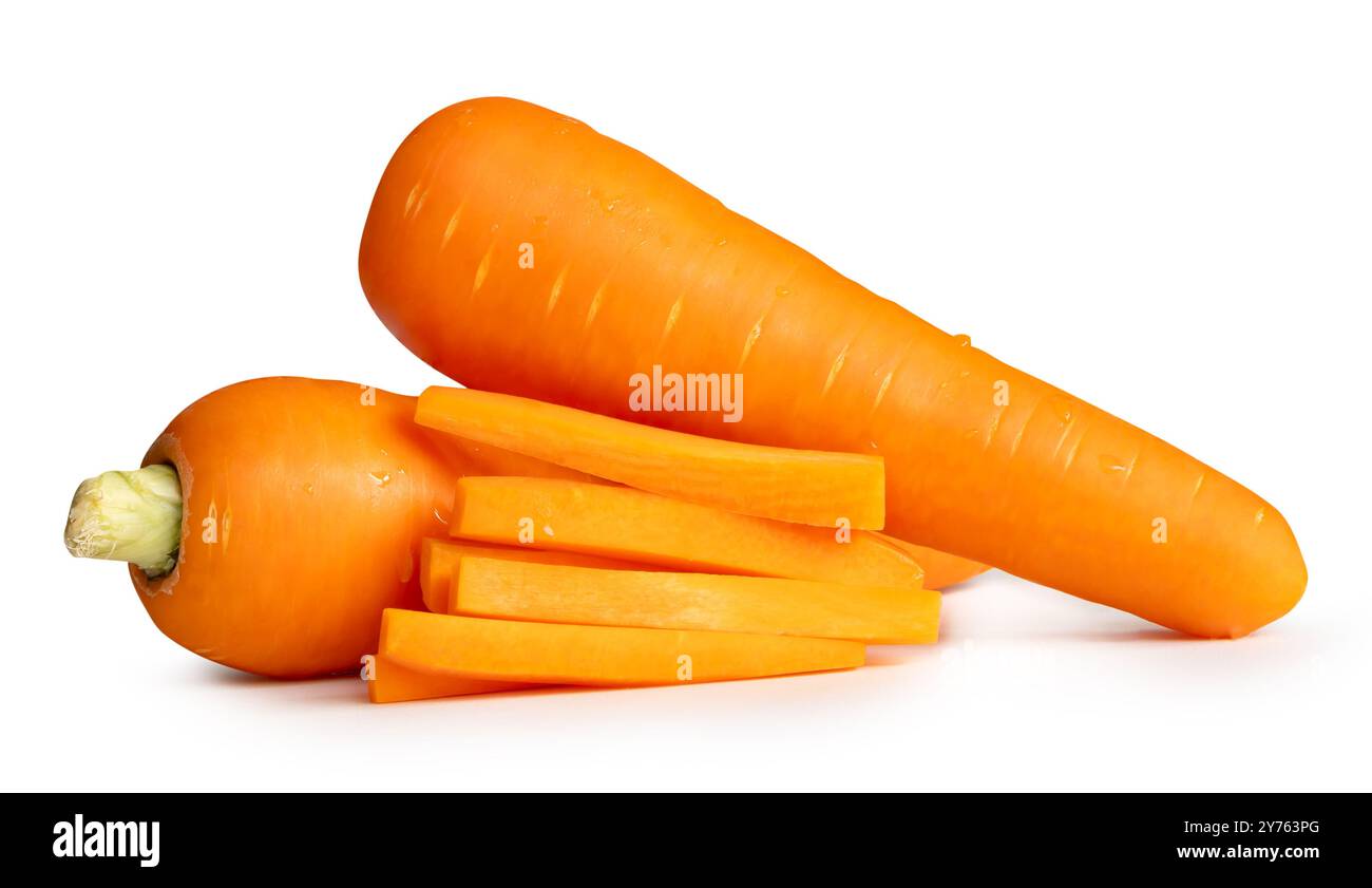 Side view of orange carrot roots with slices in stick shape in stack is ...