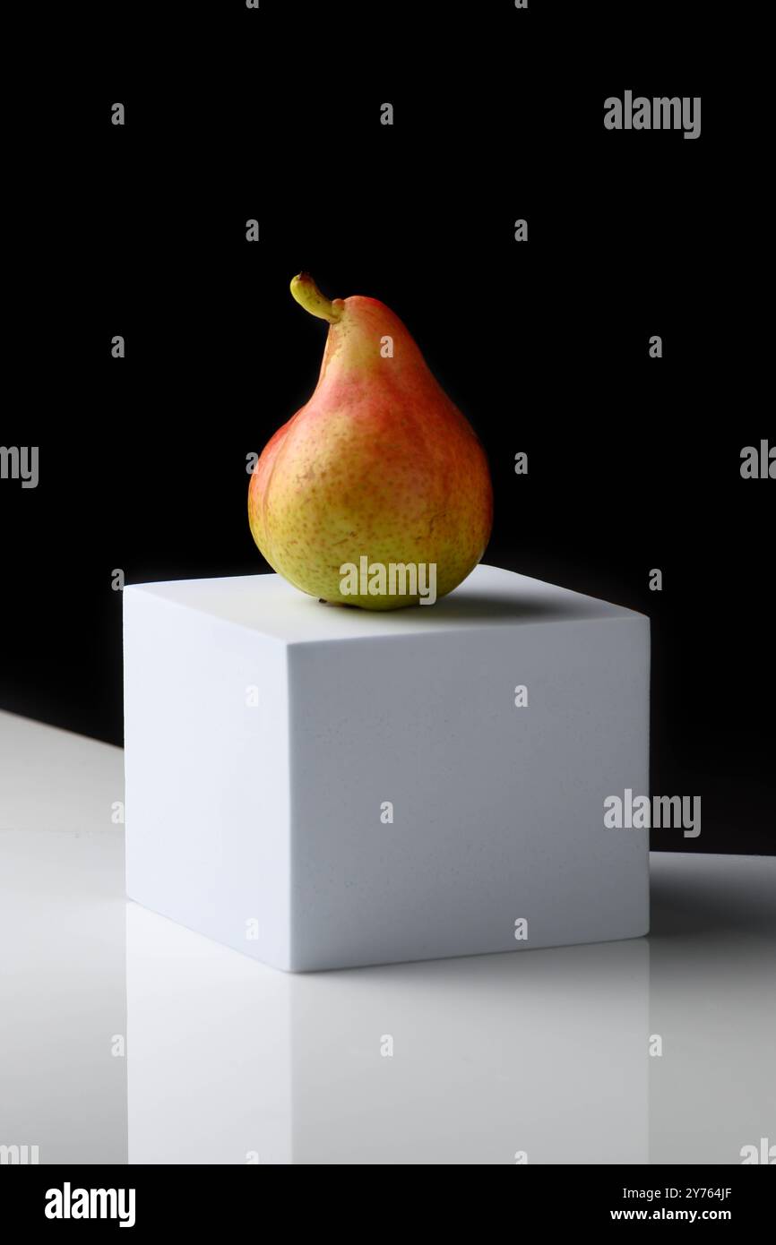 beautiful pear under white cube Stock Photo - Alamy