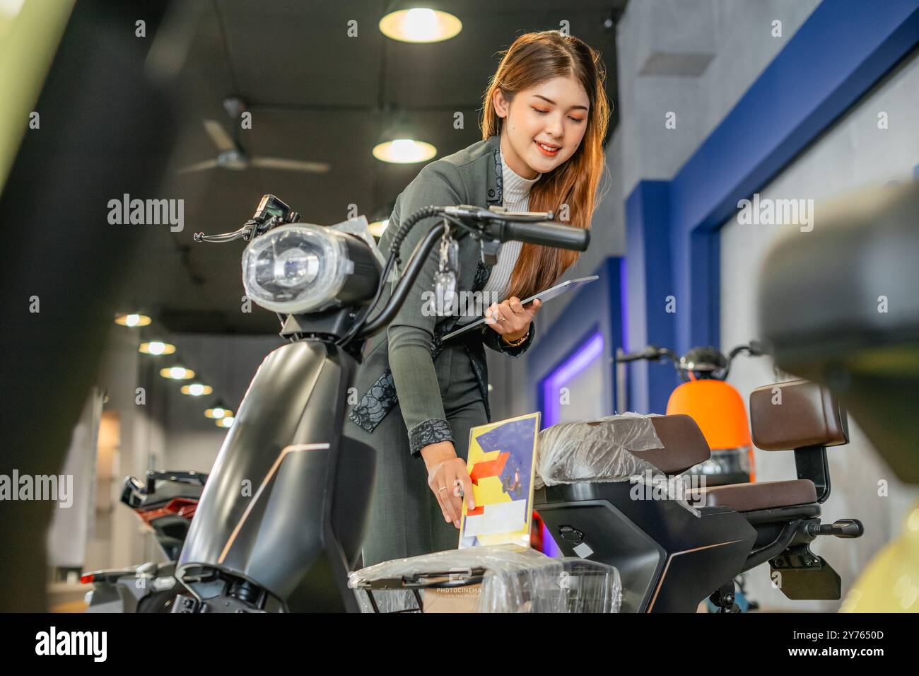 asian saleswoman putting brochure pamphlet electric bicycle Stock Photo ...