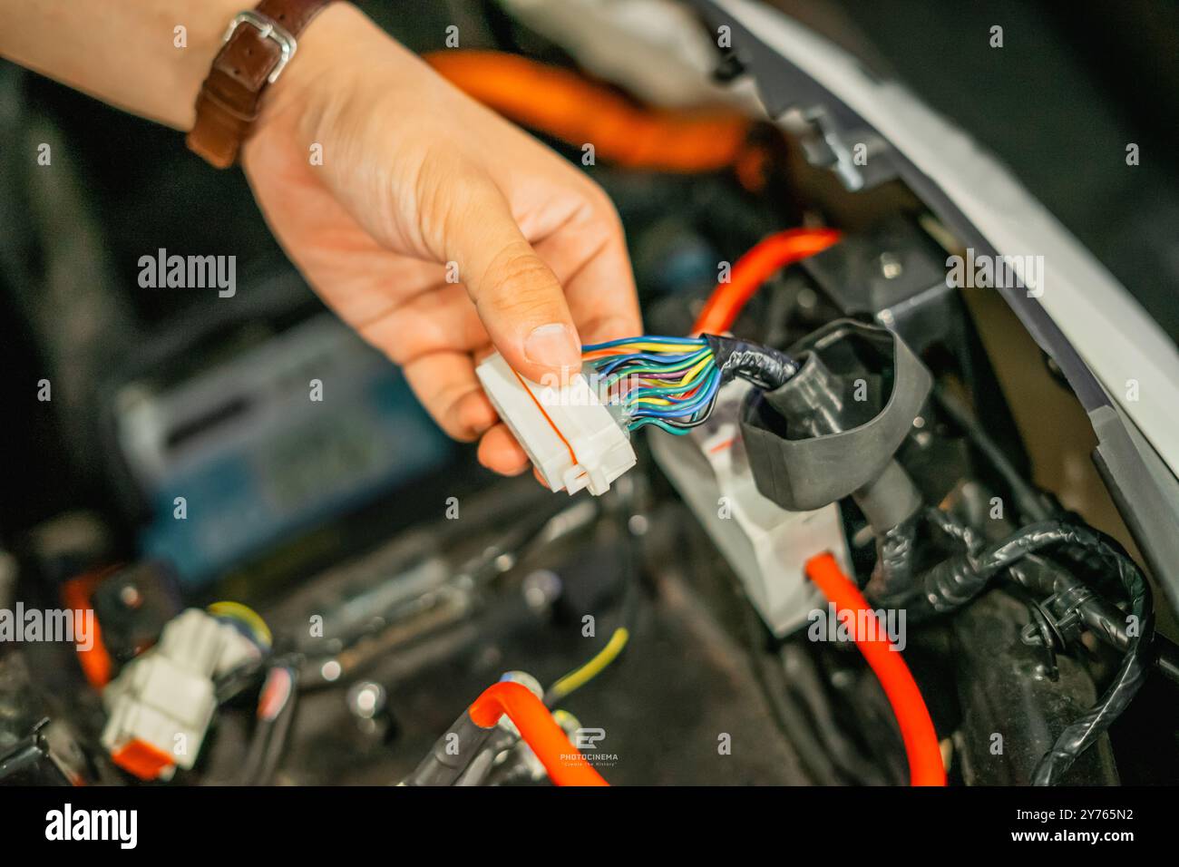 male hand inspecting checking electric vehicle engine Stock Photo - Alamy