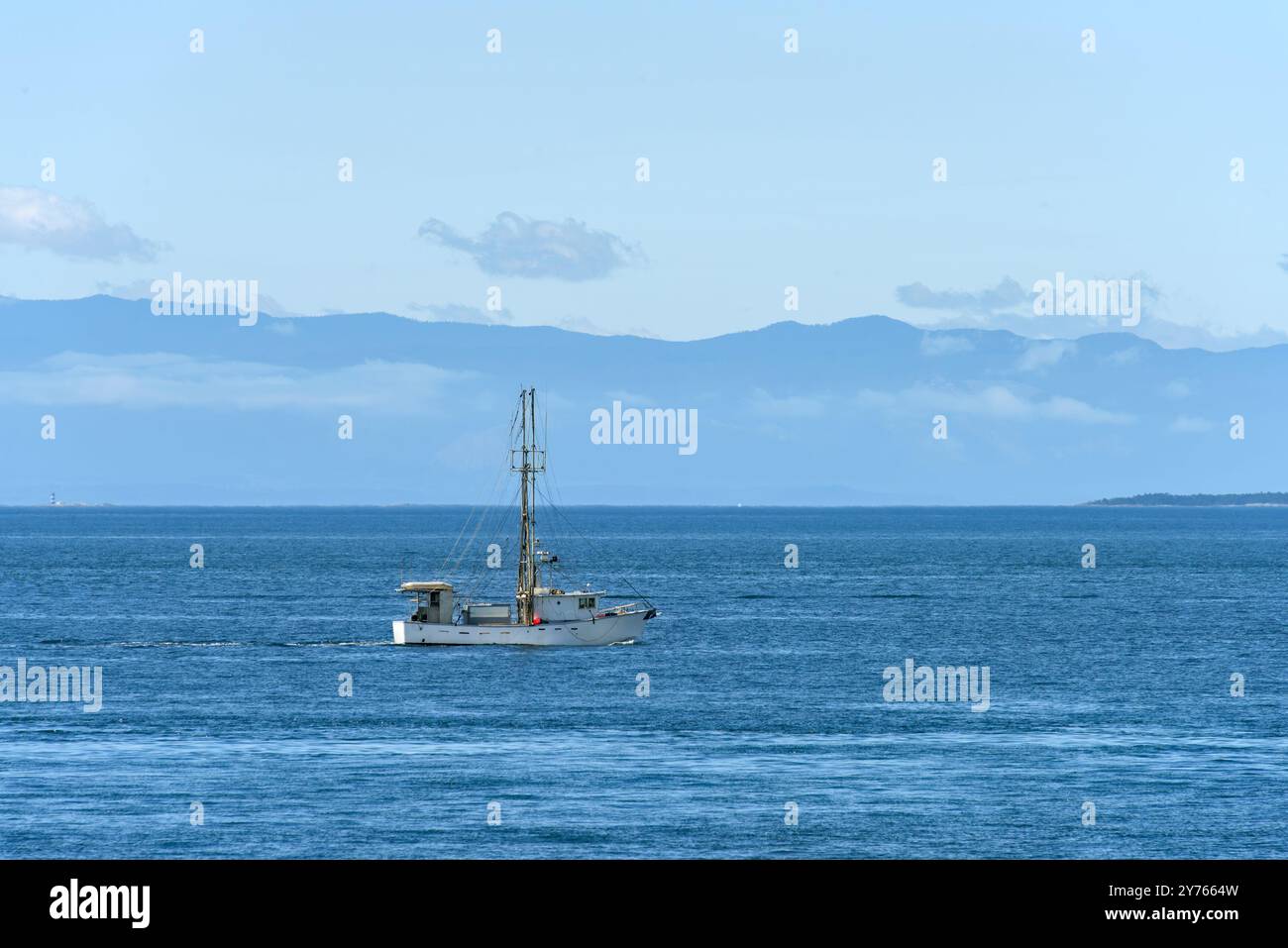 Small trawler is going to the fishing reid in Pacific ocean Stock Photo ...