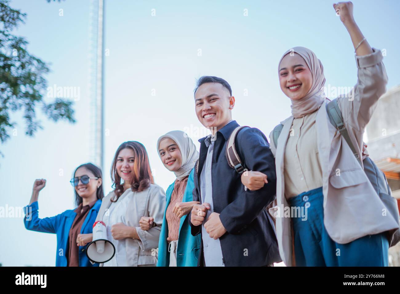 low angle shot indonesian students holding hands Stock Photo - Alamy
