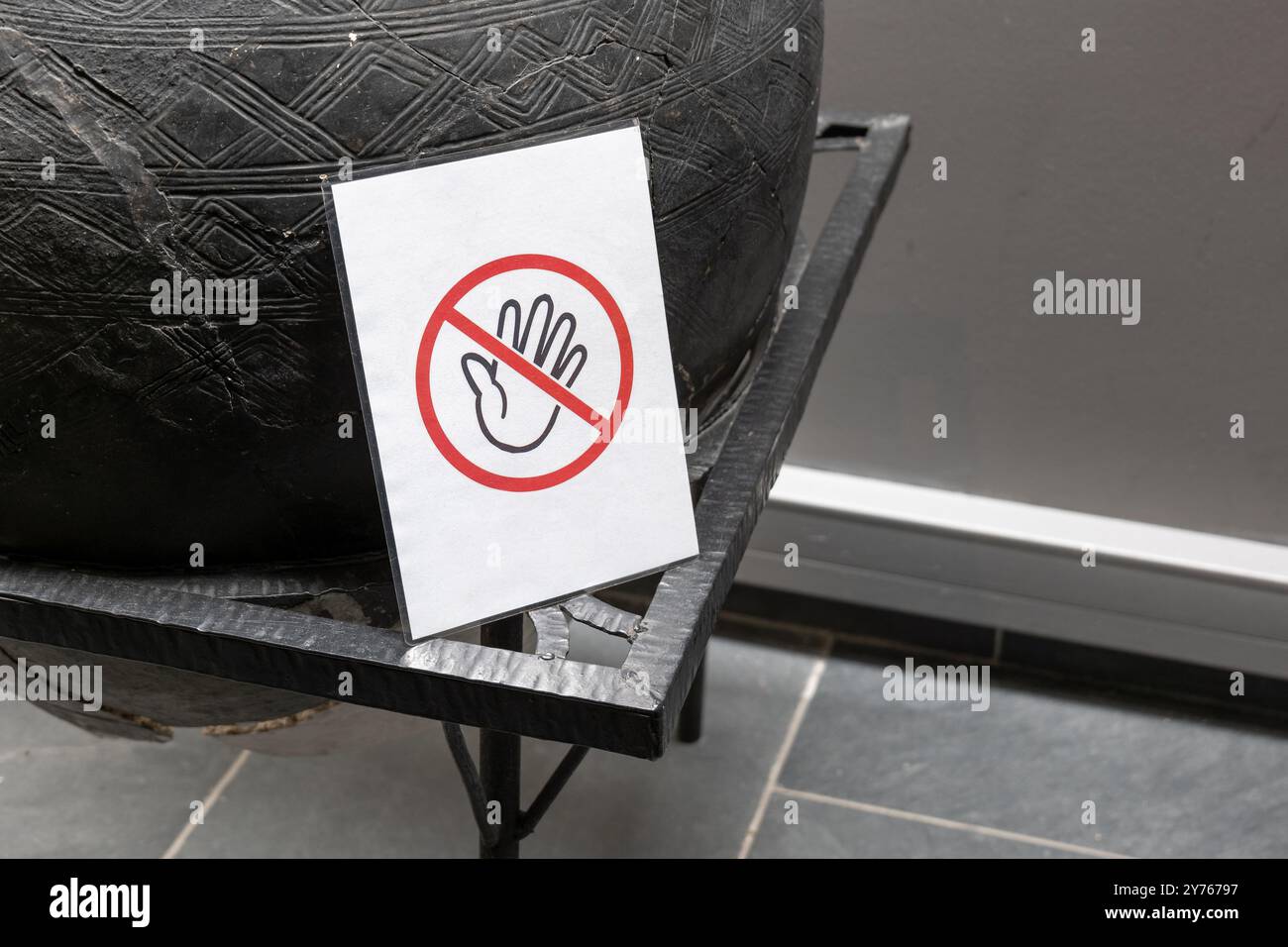 A simple do not touch label warning sign with a crossed out hand symbol ...