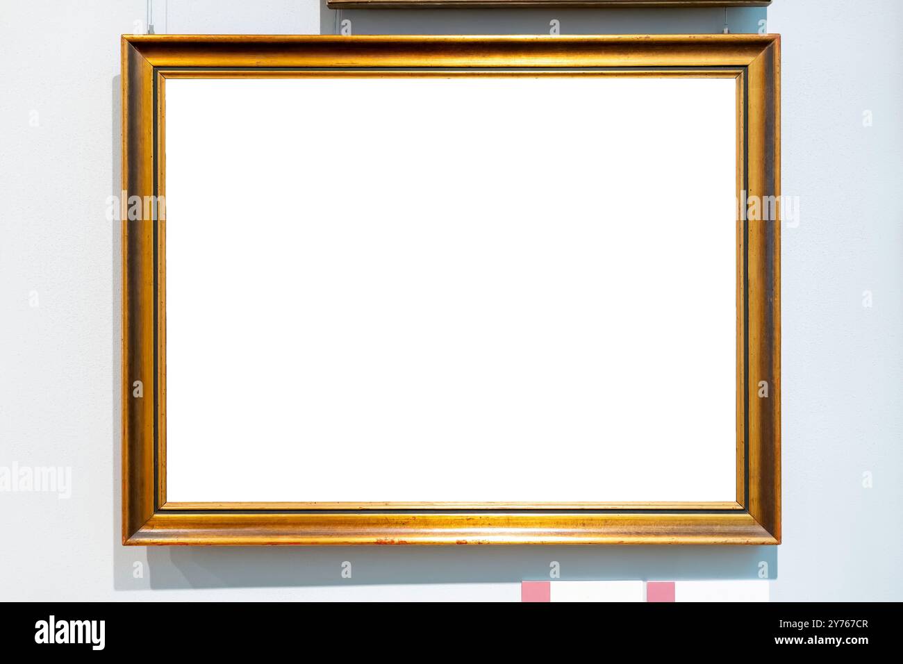 Plain simple middle size blank empty gold painting frame, hanging on a ...
