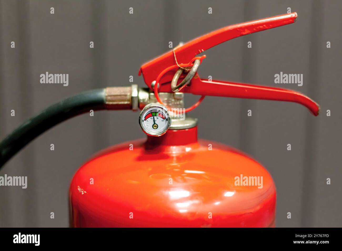 Classic red fire extinguisher handle and pressure dial gauge meter ...