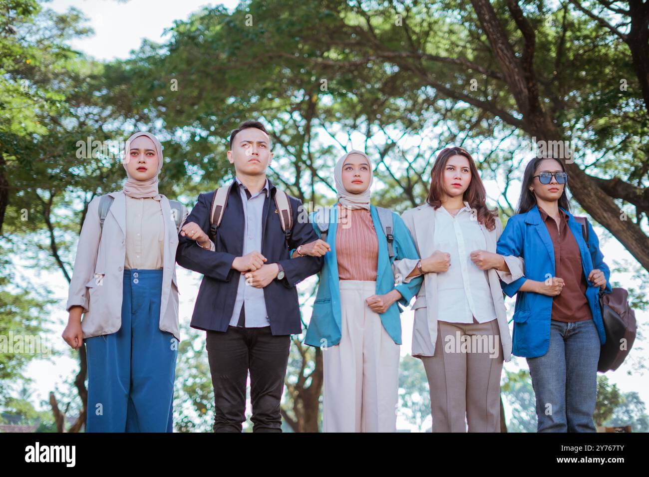 low angle shot student group standing together holding hands Stock ...