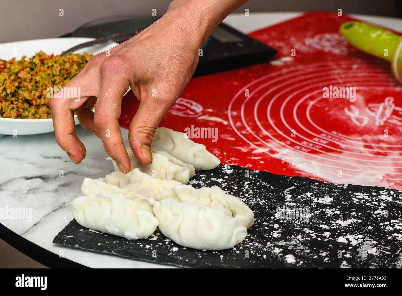 Hand molding. Dough with meat. Woman sculpt dumplings with her hands ...