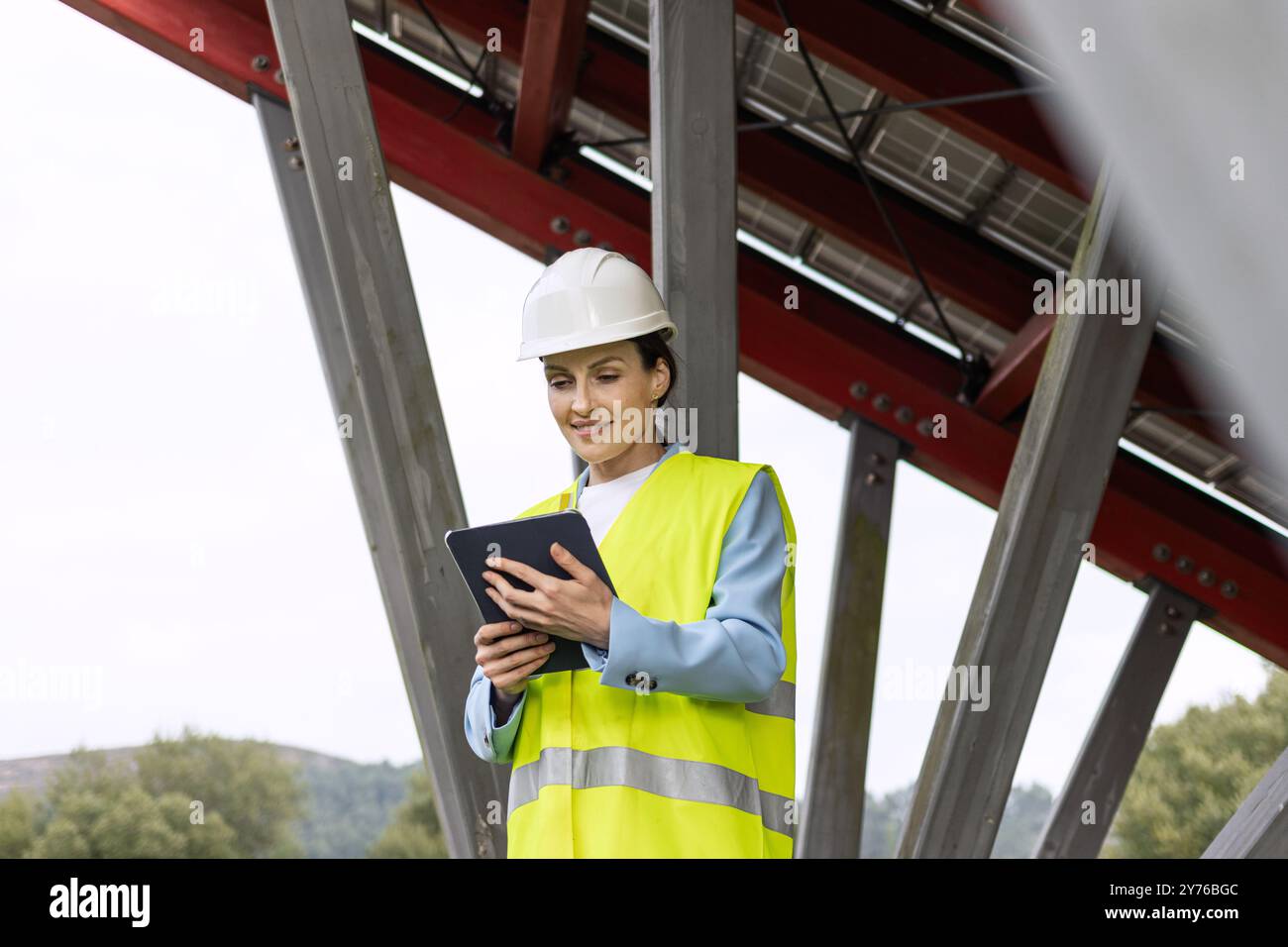 Female Solar energy engineer working outdoor on ecological solar farm ...