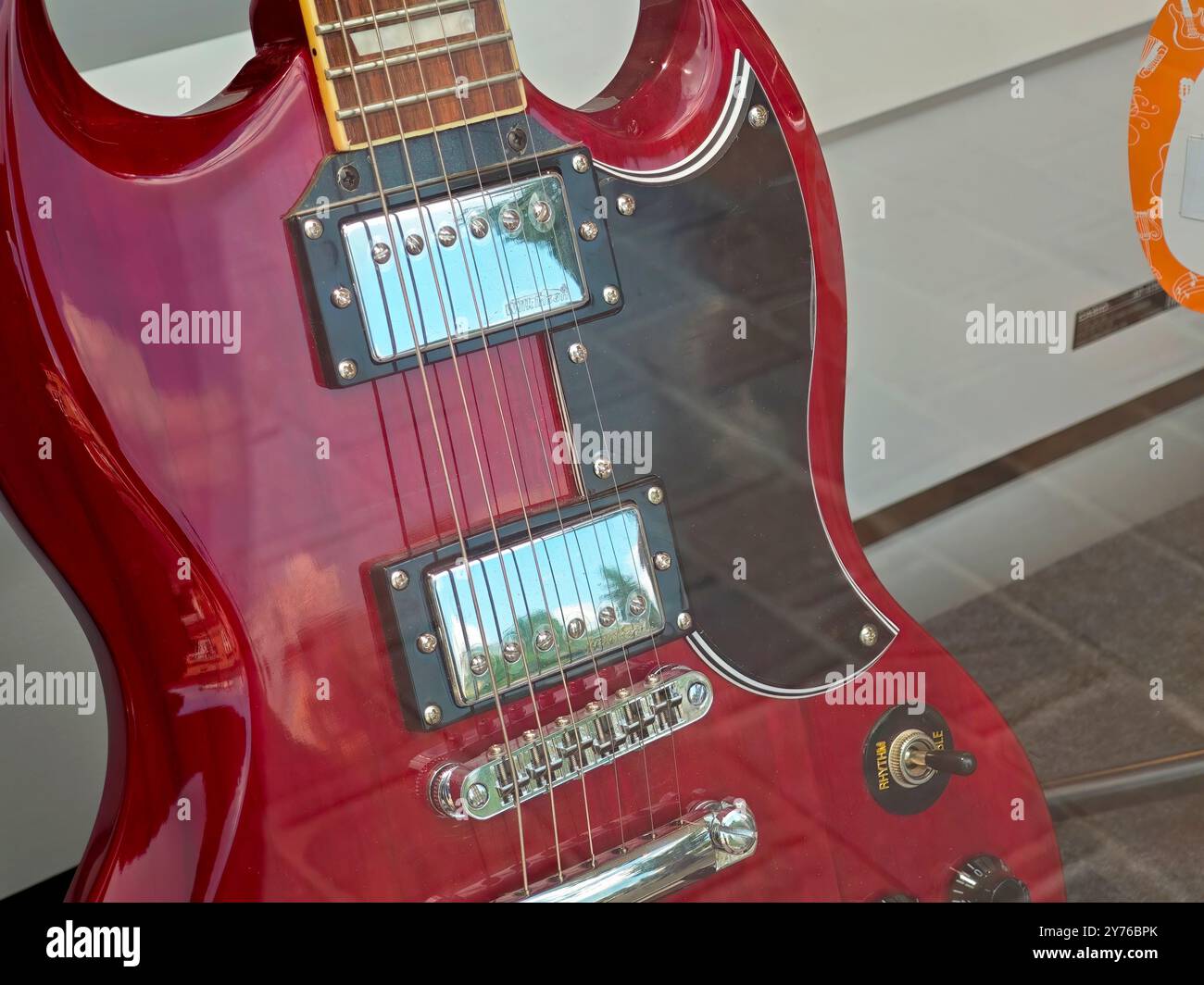 Red double-cutaway shape SG design guitar on a guitar store display ...