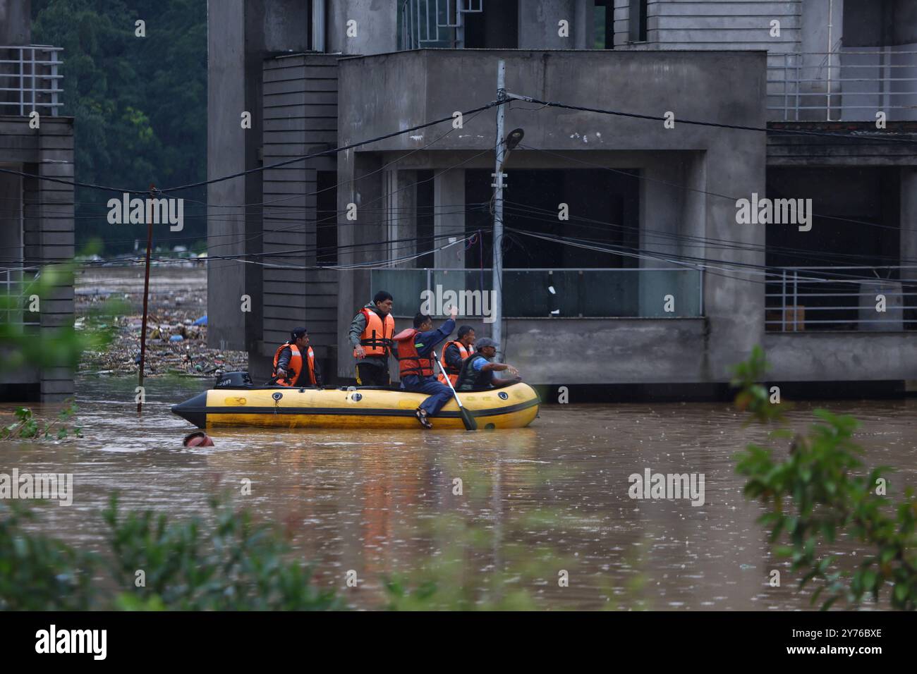 Kathmandu, Nepal. 28th Sep, 2024. Rescuers sail in an inflatable boat in a flooded neighborhood ...