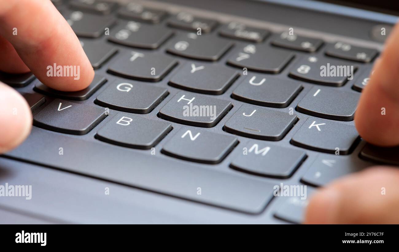 Man typing fast on a new gray modern laptop keyboard, closeup, real ...
